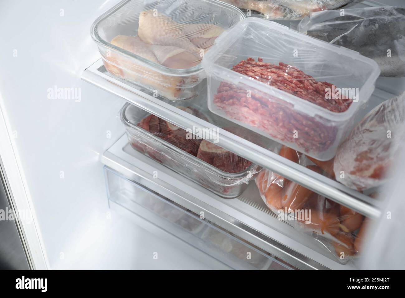 Different frozen meat products on shelves in fridge Stock Photo - Alamy