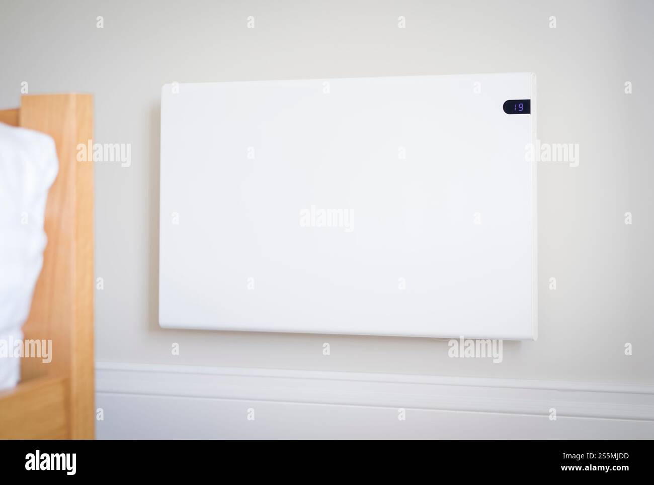 Modern electric heating panel radiator on a bedroom wall, home interior ...