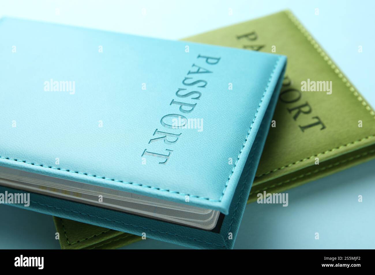 Passports in color covers on light blue background, closeup Stock Photo ...