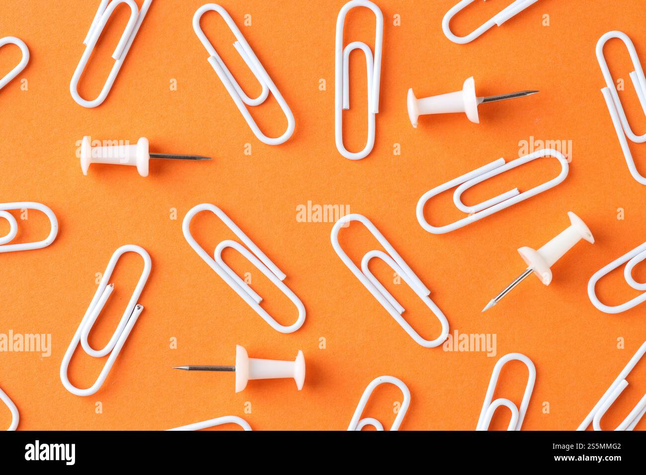 Paper clips and pins on orange background, flat lay Stock Photo - Alamy