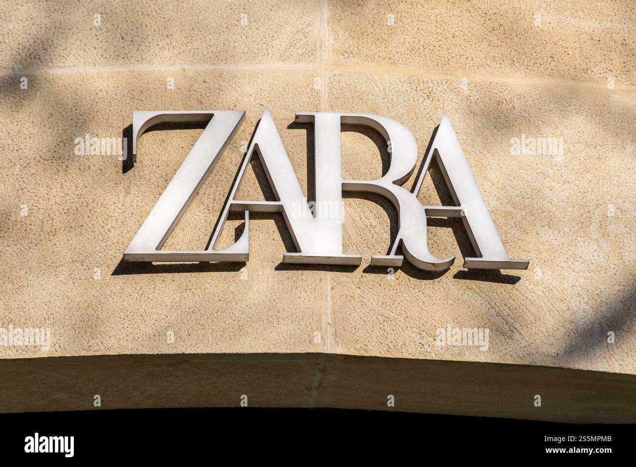 Sign and logo at the entrance to a Zara store. Zara is a is a fast ...