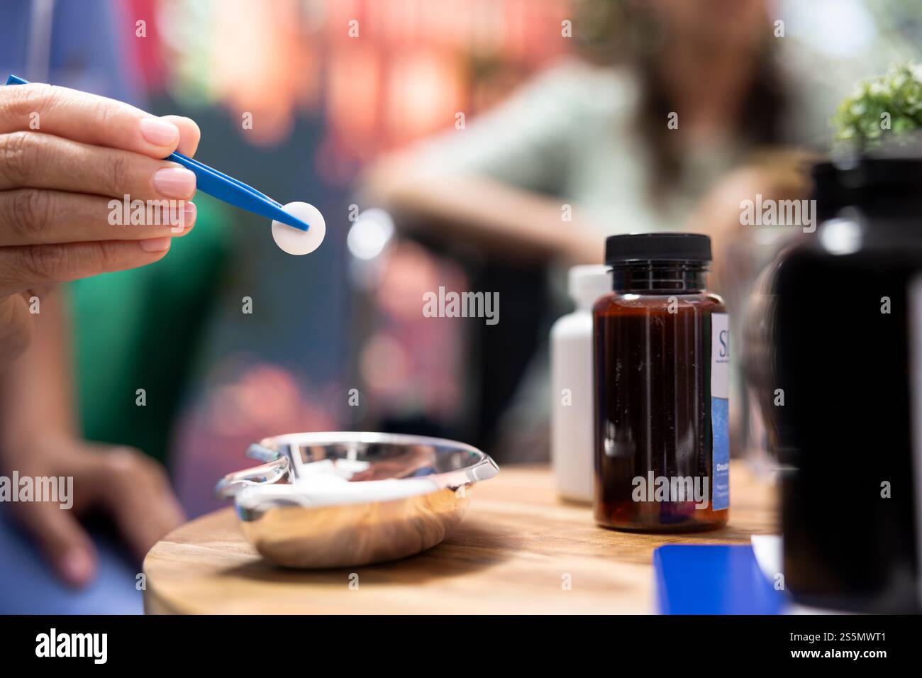 Medical assistant preparing daily dose of pills and vitamins for ...