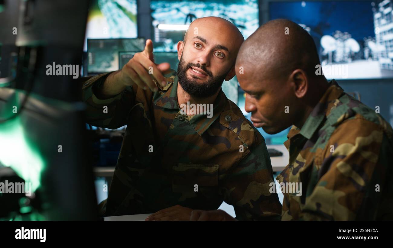 Army unit working in governmental facility next to coworker, doing brainstorming, operating ...