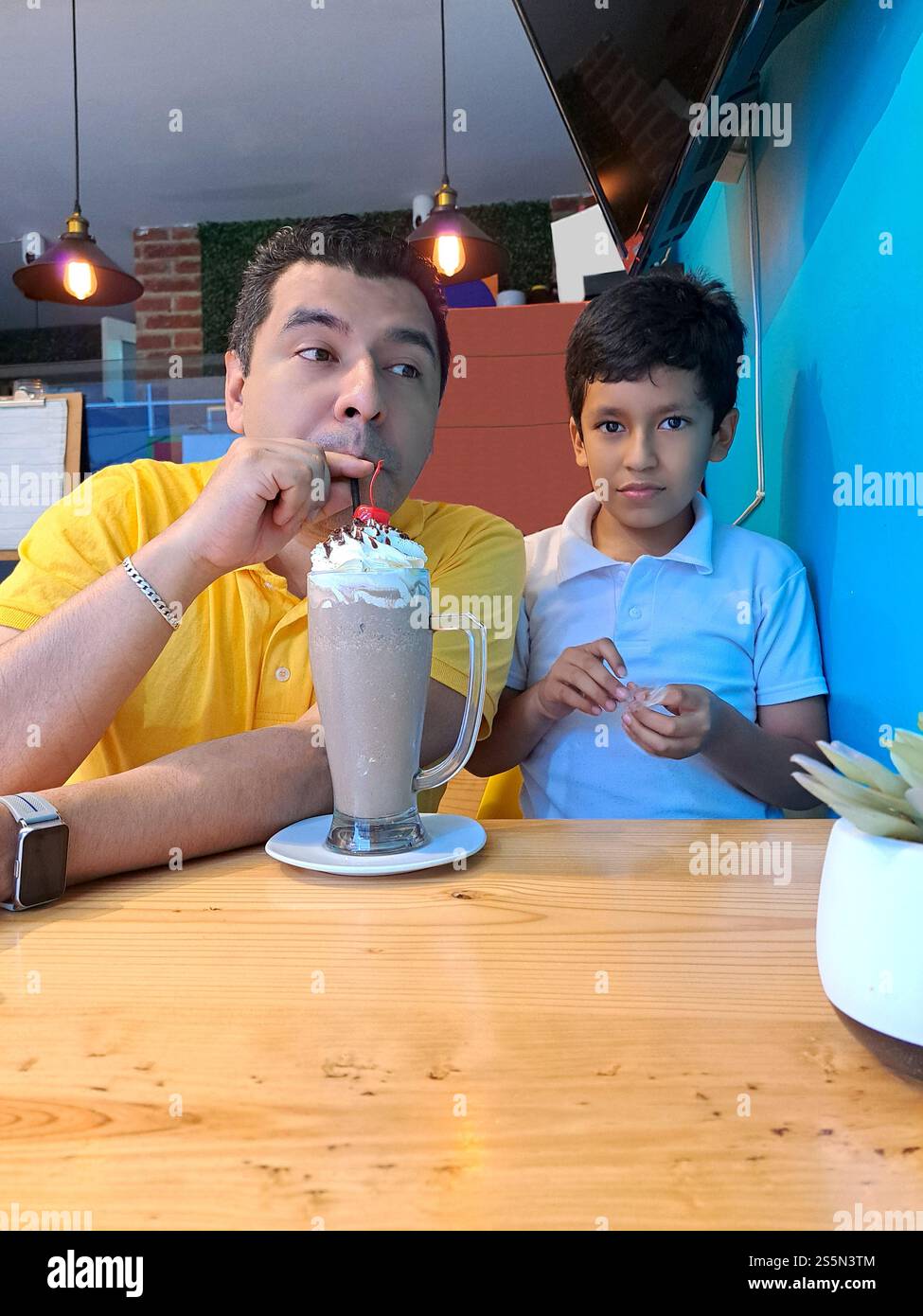 Divorced single dad with his 9 year old son have a milkshake in a ...