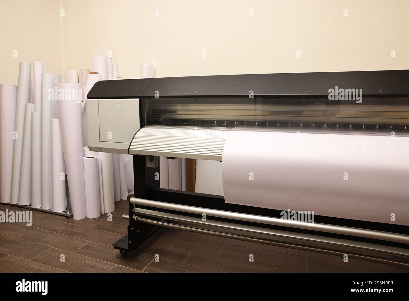 Wide-format printer with paper indoors. Printing house Stock Photo - Alamy