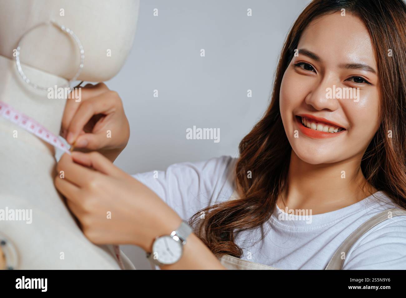 Portrait of young pretty female fashion designer stylish smile during ...