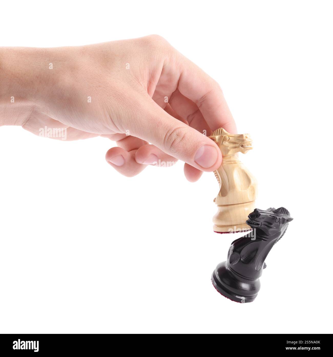 Man with white chess knight knocking over black one on white background ...