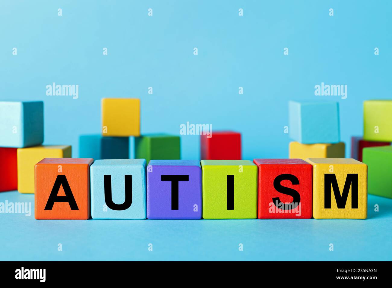 Word Autism made of colorful cubes on light blue background Stock Photo ...