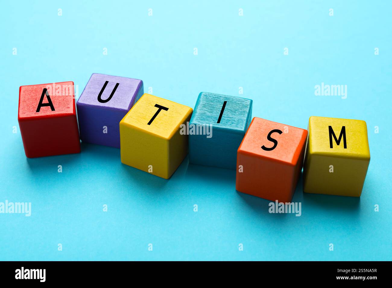 Word Autism made of colorful cubes on light blue background Stock Photo ...