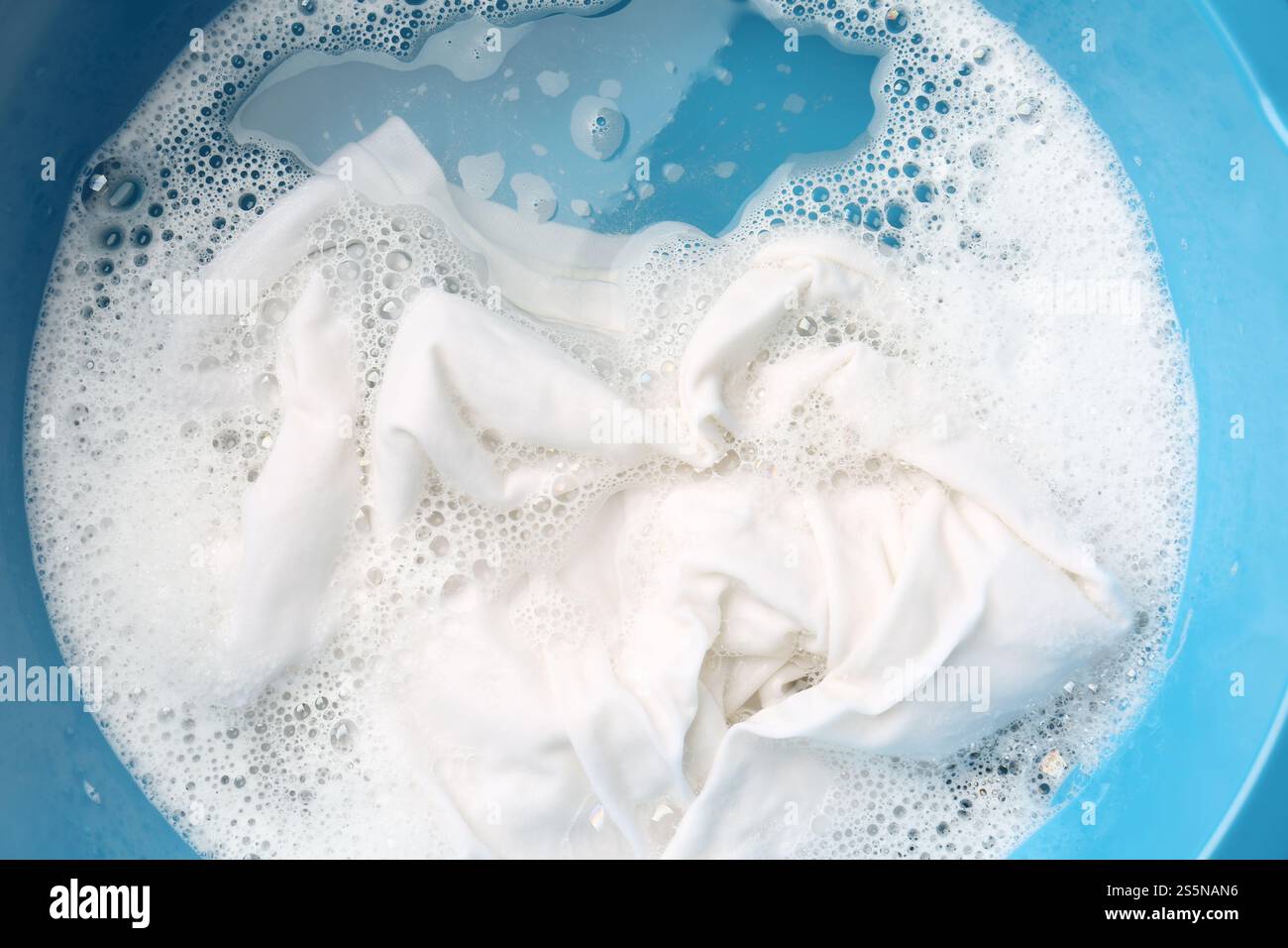 White clothes soaked in water before washing, top view Stock Photo - Alamy