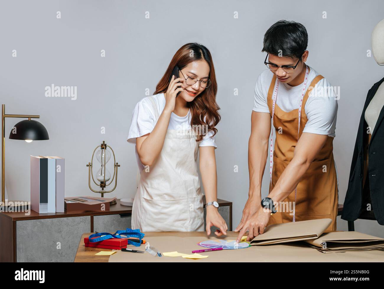 Portrait Young handsome man and pretty woman, Couple fashion designer ...