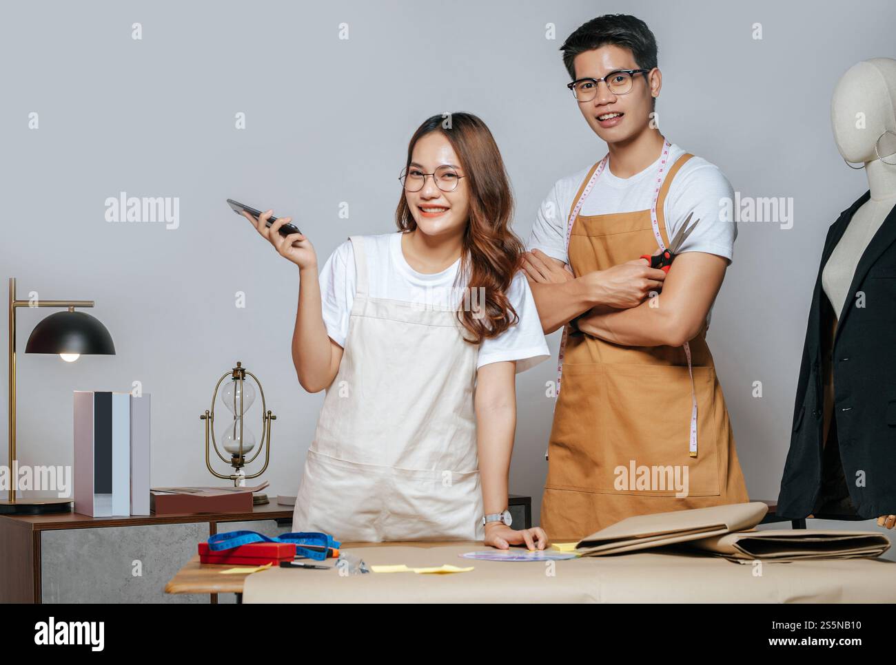Portrait Young handsome man and pretty woman, Couple fashion designer ...