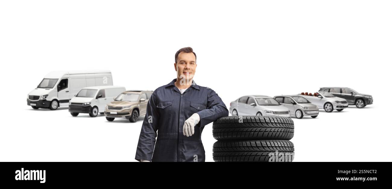 Auto mechanic worker in a uniform standing on a car parking and leaning ...