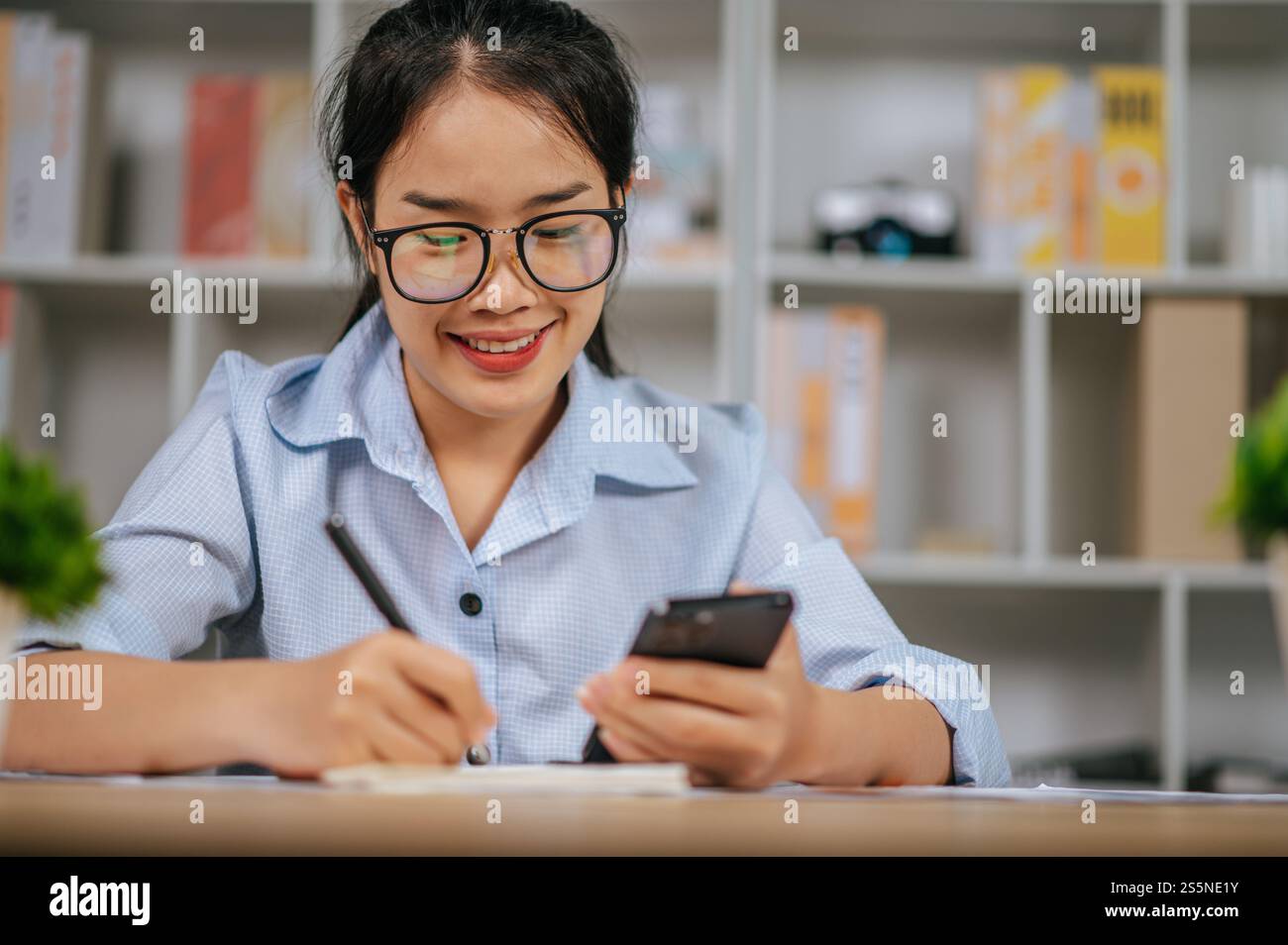 Portrait of asian young woman wearing eyeglasses working with ...