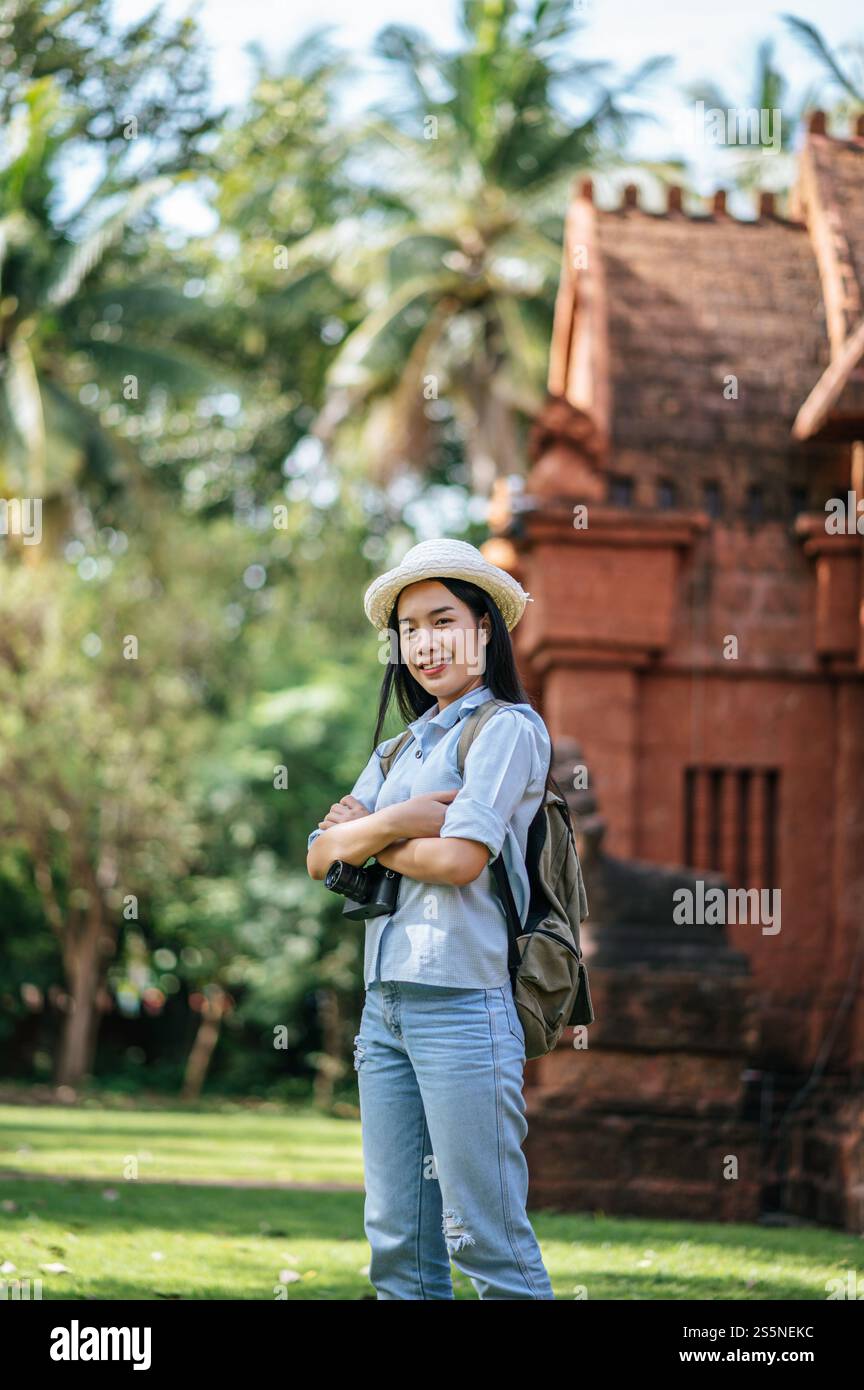 Portrait young backpacker female wearing hat traveling in ancient site ...