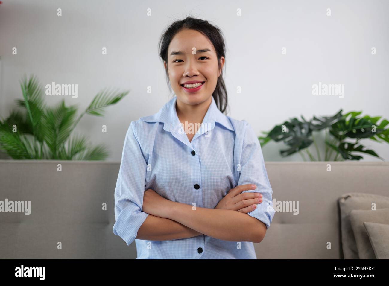 Portrait asian young woman standing and crossed arms on chest , looking ...