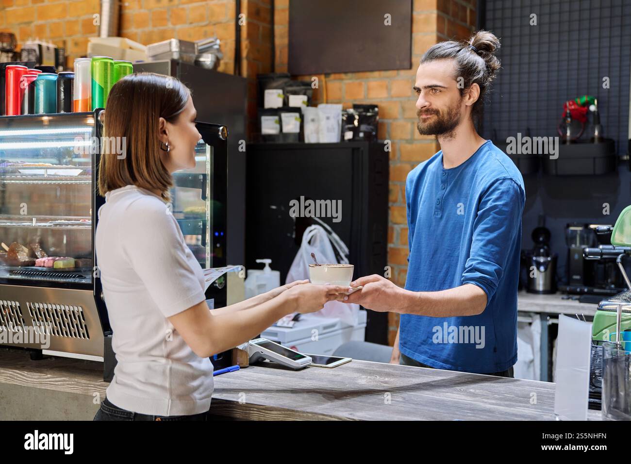 Young man cafe worker shaking hands with woman client customer ...