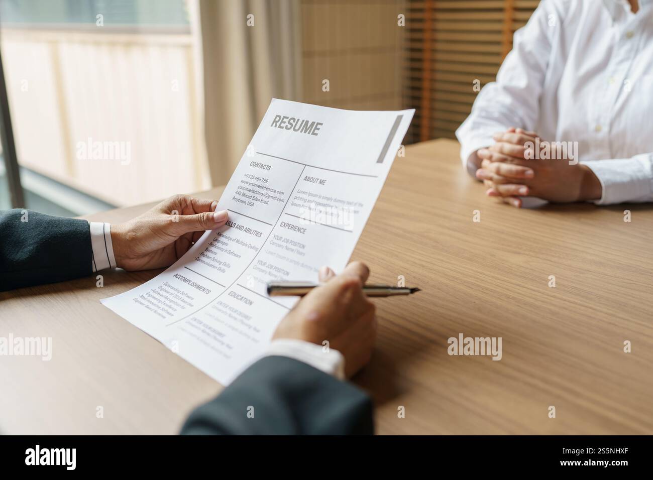 Examiner reading a resume during job interview at office Business and ...