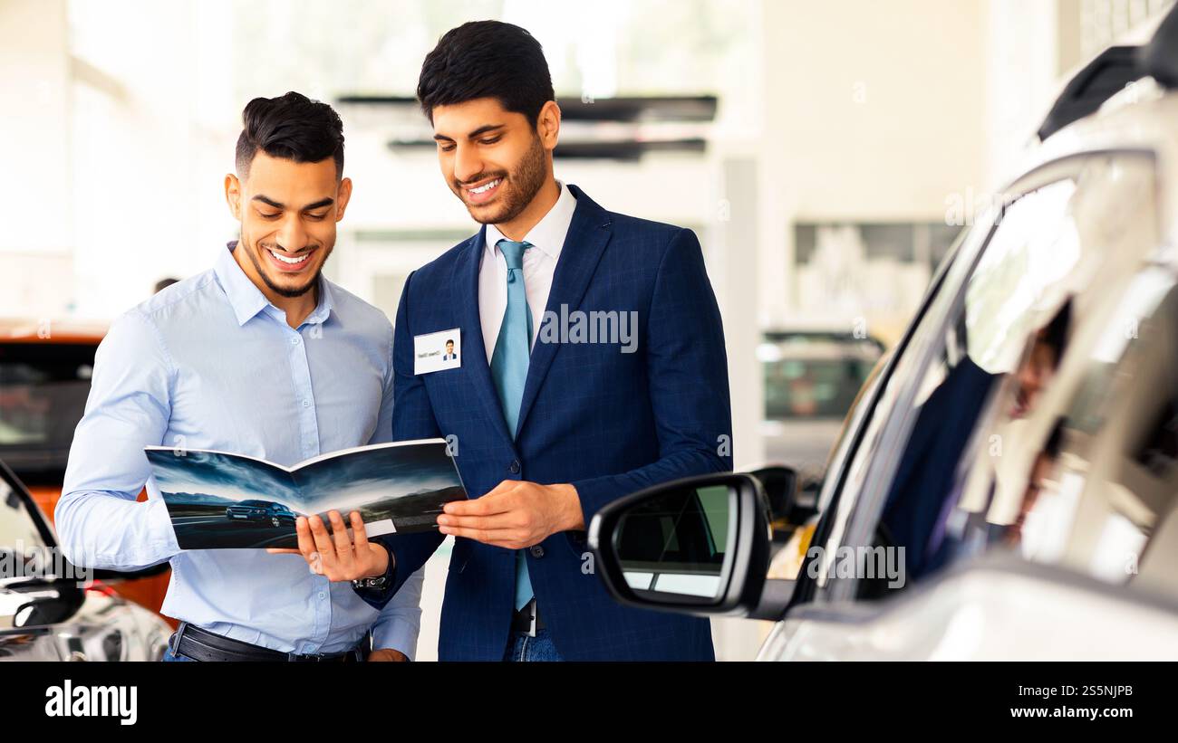 Middle-eastern guy having conversation with sales assistant in auto ...
