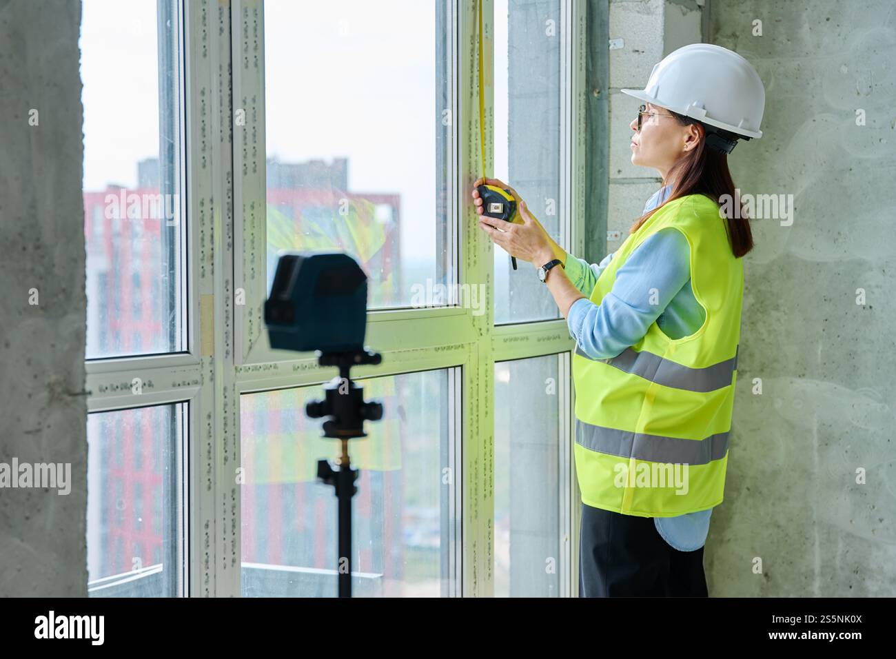 Industrial worker, woman measuring window with tape measure at ...