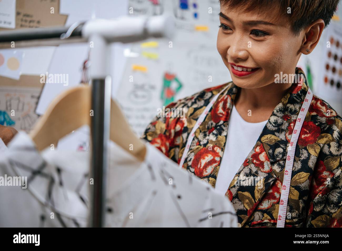 Close up, Smiley designer female proud with her clothes design on ...