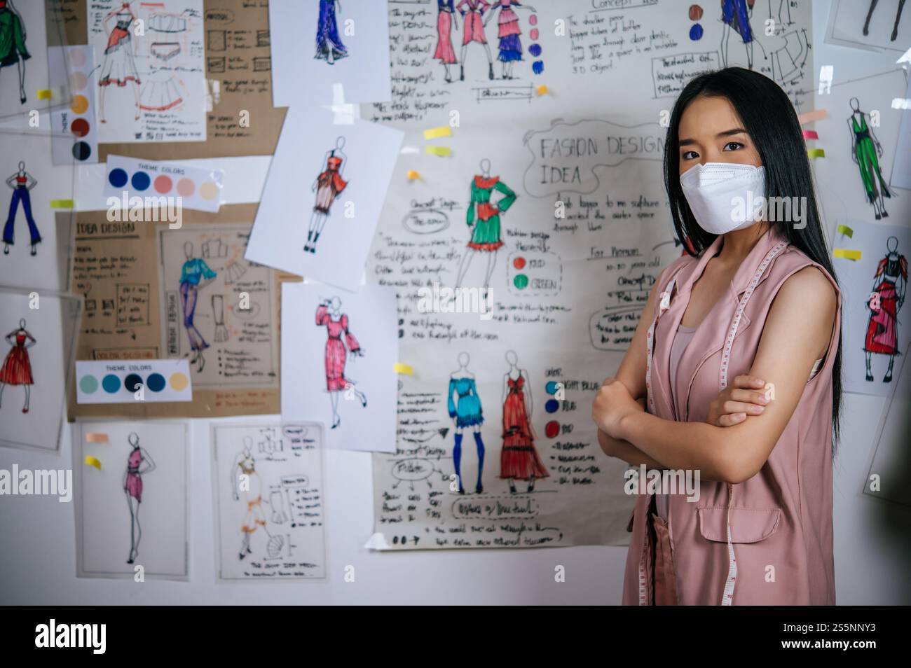 Portrait young asian female standing in modern atelier. Positive woman creative worker wearing ...