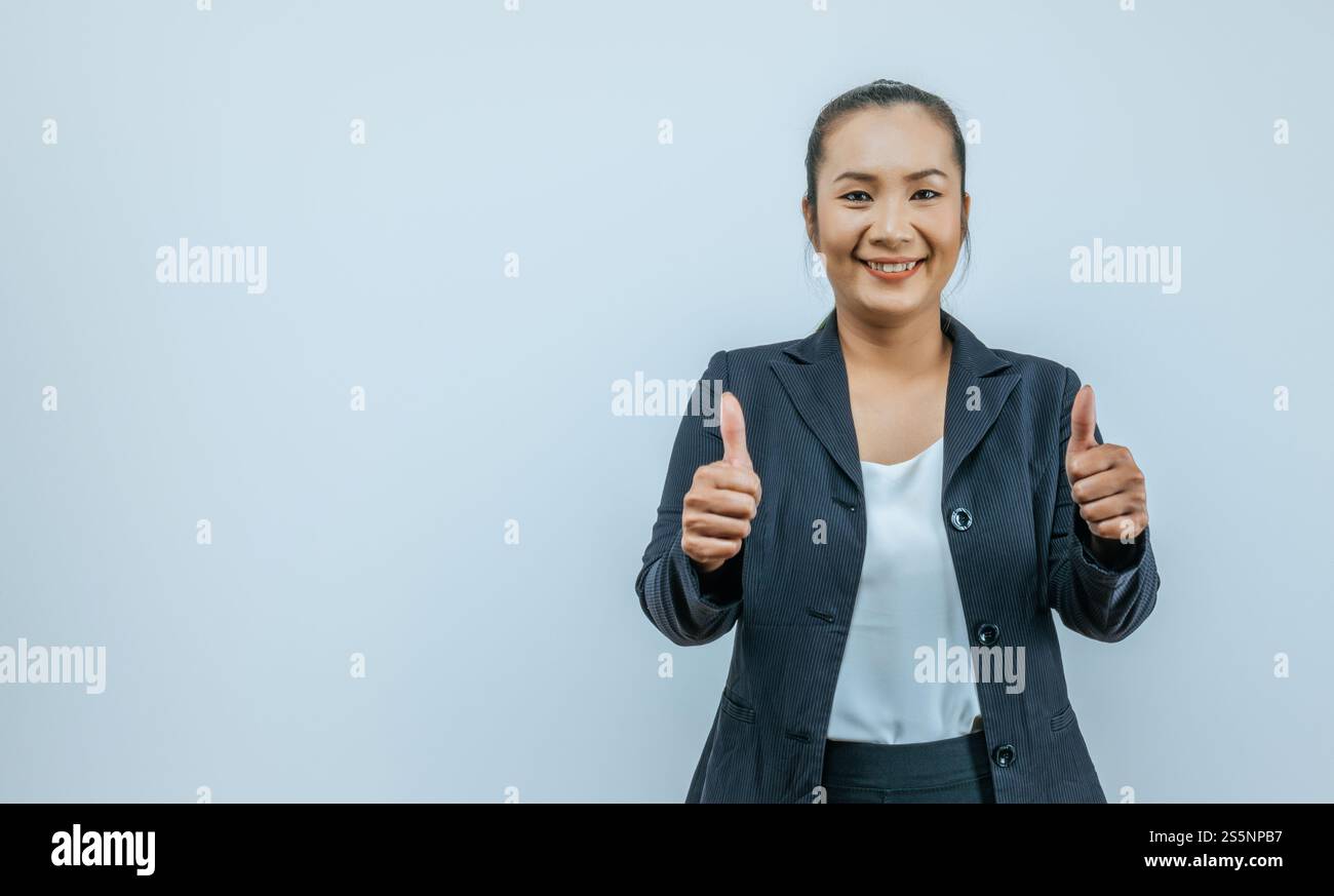 Portrait of Asian woman with two thumbs up sign gesture, isolated on background with copy space ...
