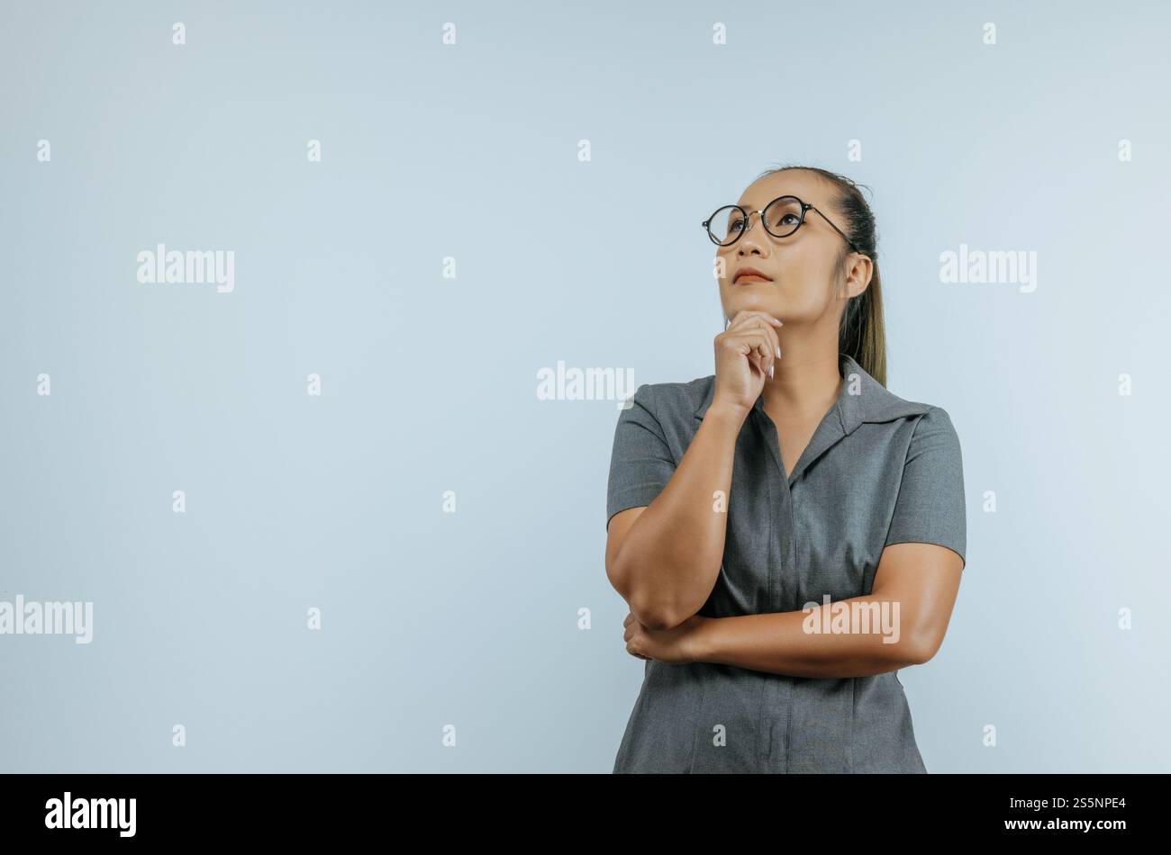 Portrait of Serious Asian woman glasses 30s in casual clothes looking ...