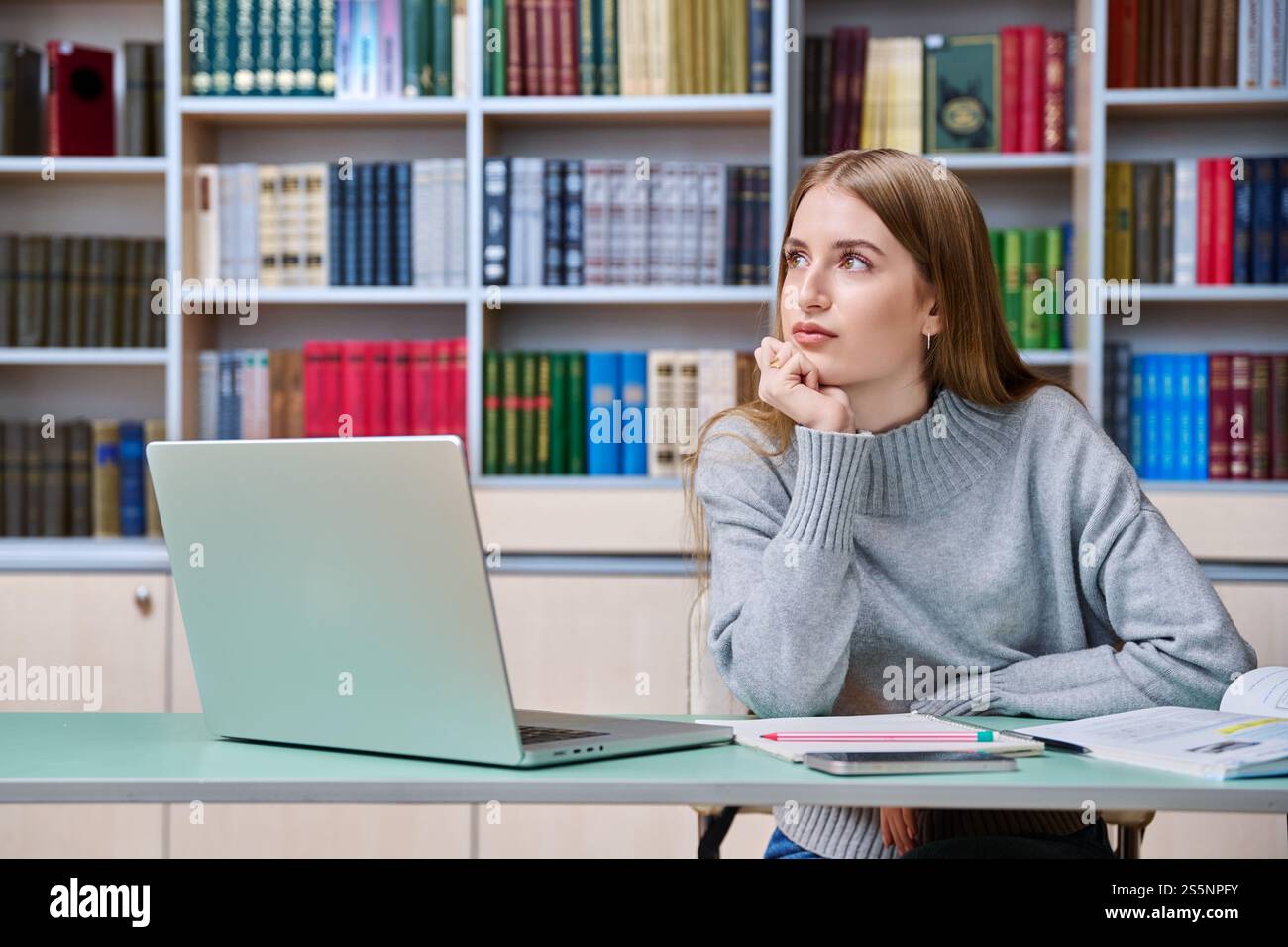 Teenage girl student studying in high school library Stock Photo - Alamy