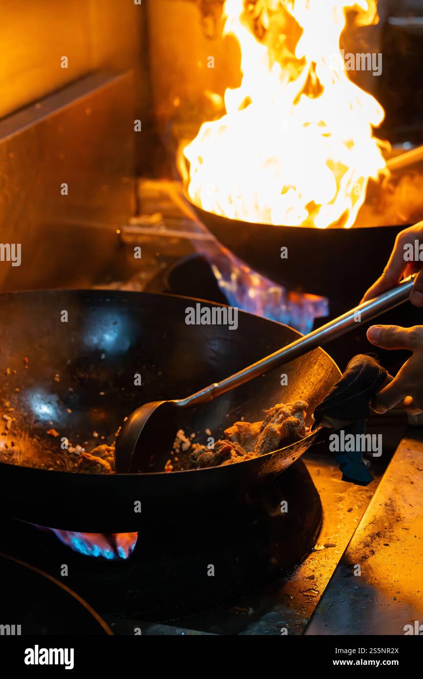 Wok cooking in a restaurant Stock Photo - Alamy