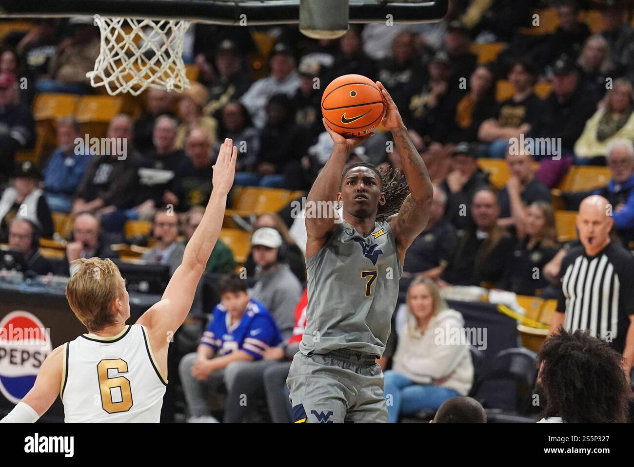 West Virginia guard Javon Small (7) shoots over Colorado forward Trevor ...