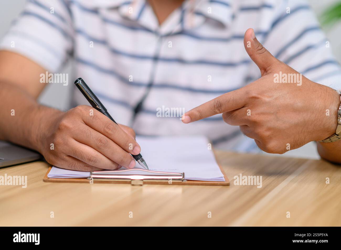 Male manager putting his ideas and writing business plan at workplace ...