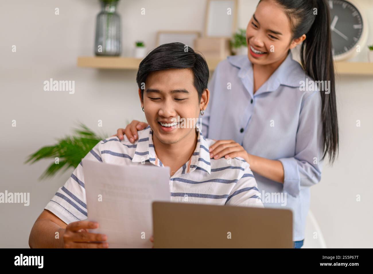 Male and female employees work together happily in the office Stock ...