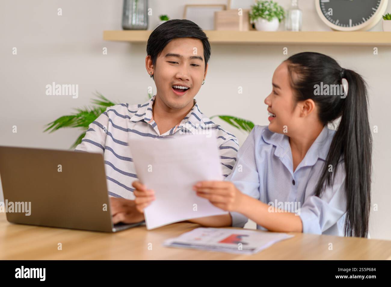 Male and female employees work together happily in the office Stock ...