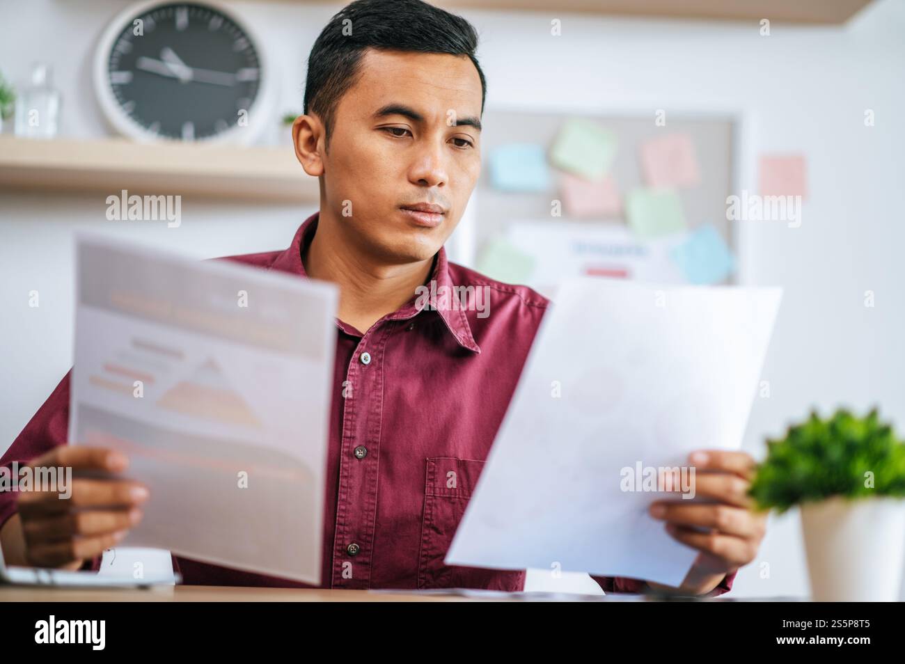 The manager checks the paperwork and is stressed Stock Photo - Alamy