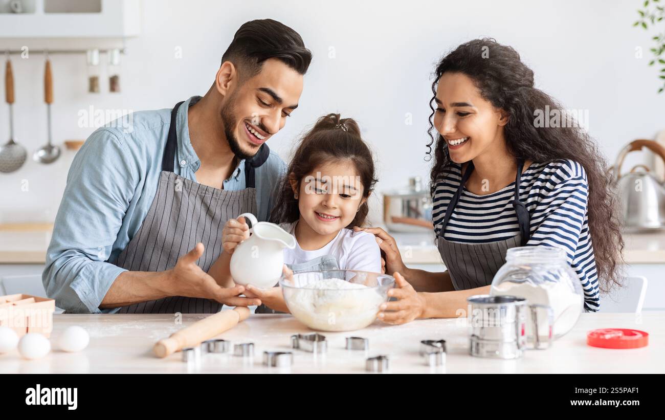 Happy middle-eastern family making homemade cookies together Stock ...