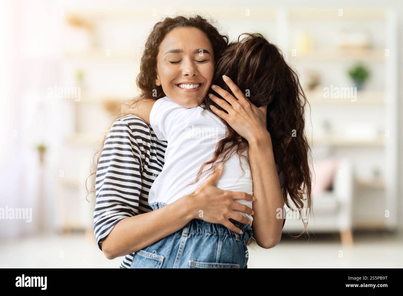 Happy middle-eastern mother hugging her little daughter Stock Photo - Alamy