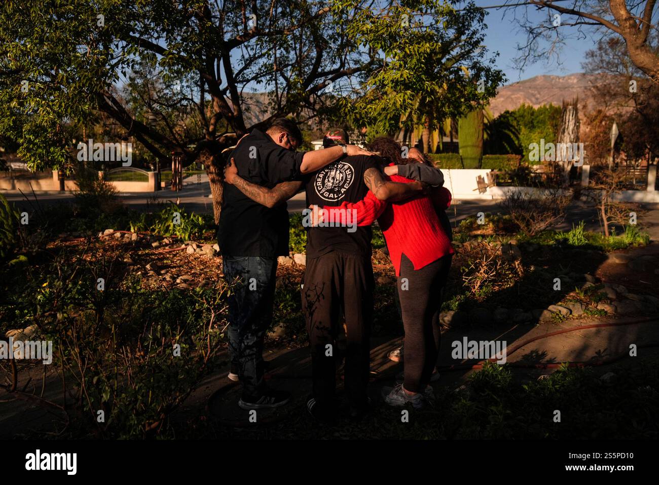 The Johnson family, whose home is one of the few that survived the ...