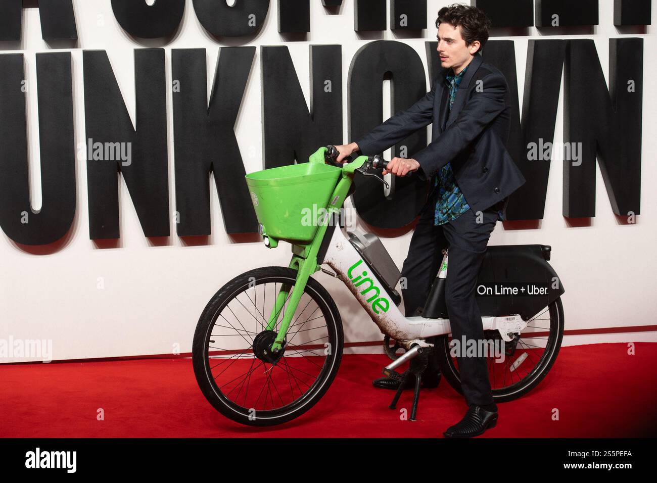 London, UK. 14 Jan, 2025. Pictured: Timothee Chalamet rides a Lime Bike onto the red carpet at ...