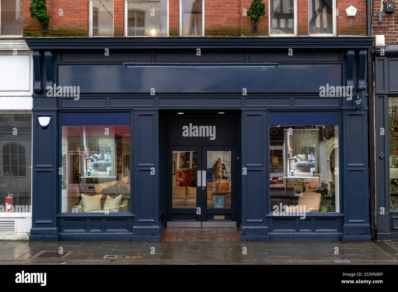 An elegant dark blue storefront in a historic urban setting, featuring ...