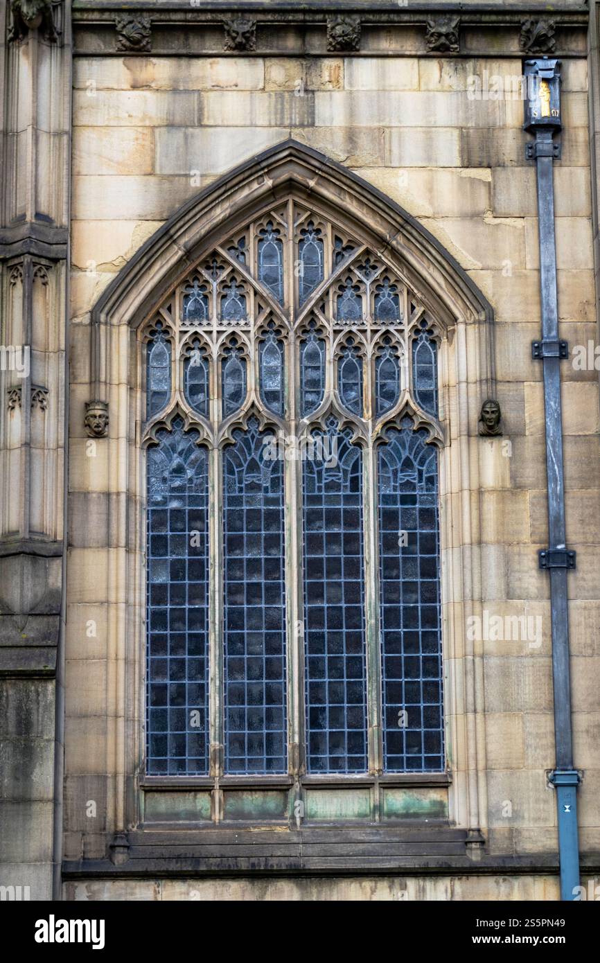 A close-up view of the intricate Gothic window design at Manchester ...