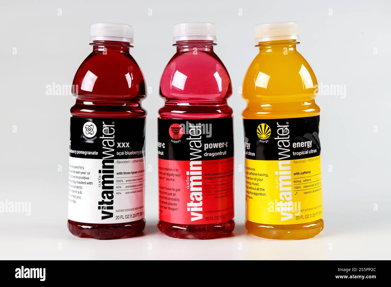 Various flavored bottled drinks on display with vibrant colors and ...