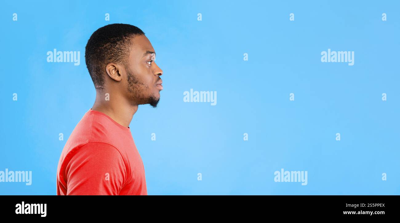 Side-View Portrait Of Serious African American Man Over Blue Background ...