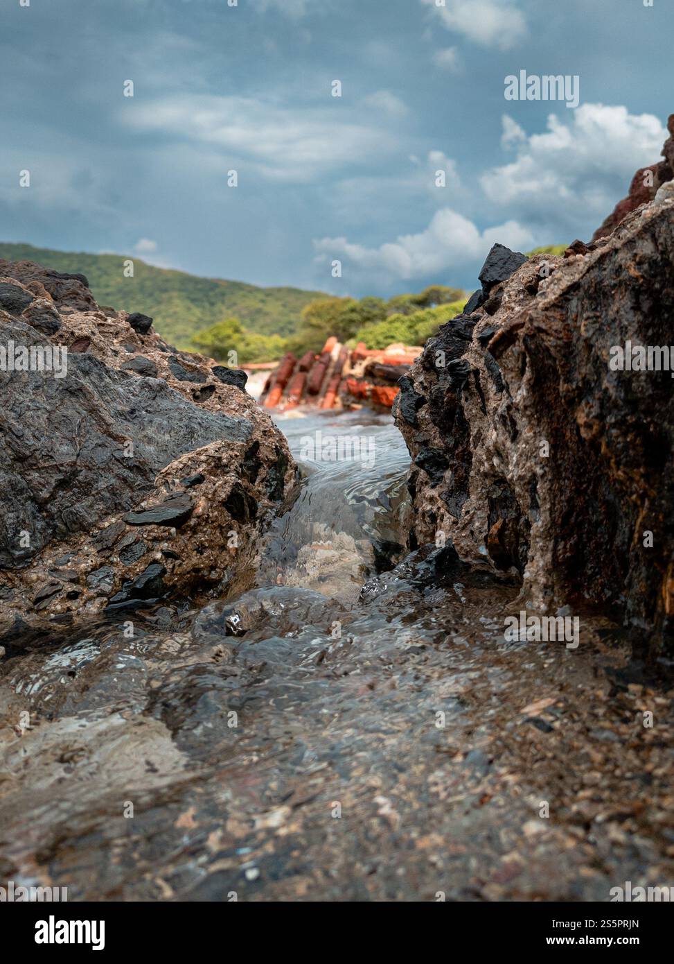 A clear stream winds its way between rugged rocks in the breathtaking ...