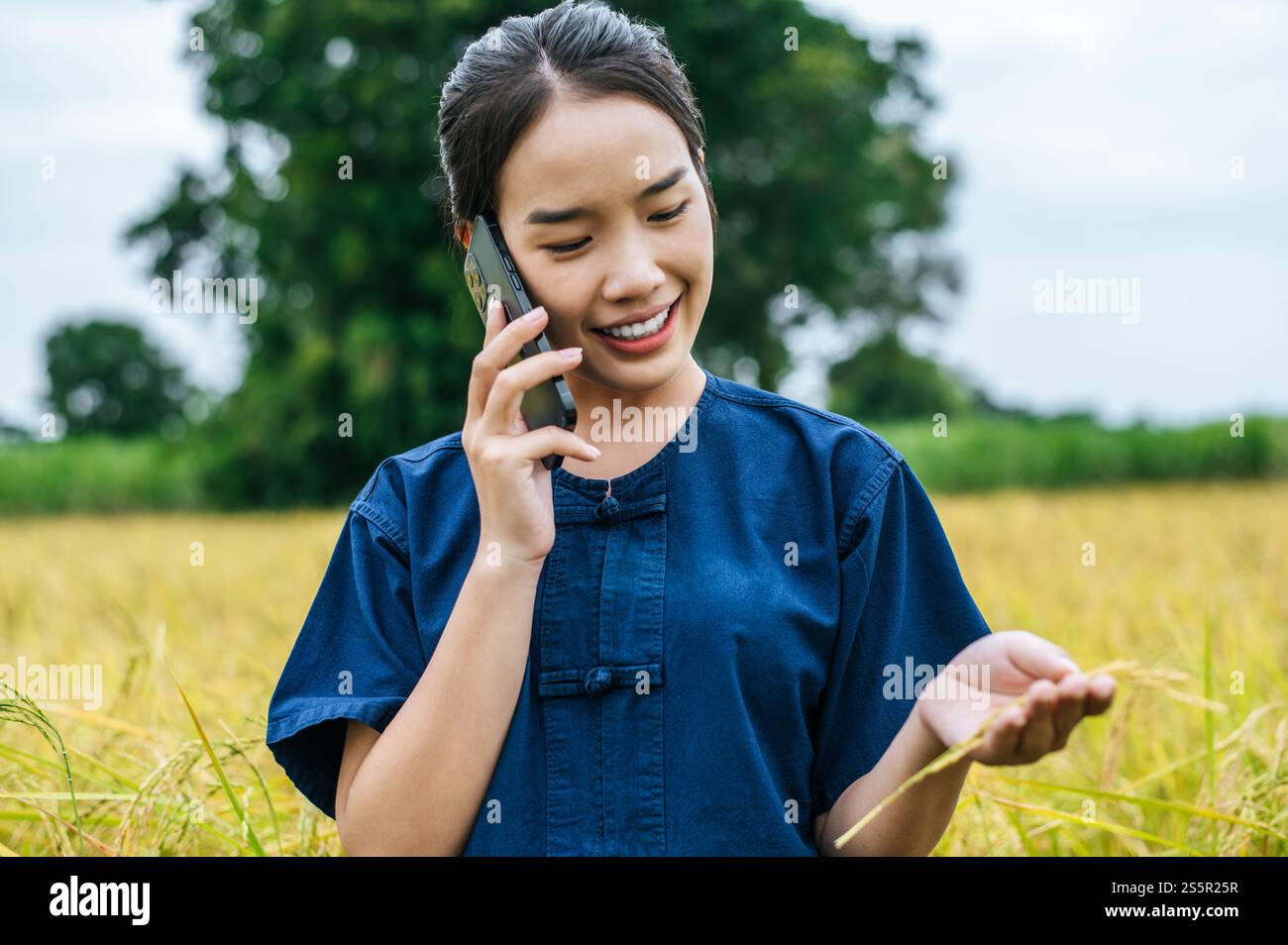 Portrait beautiful Asian young woman farmer use smartphone in organic ...