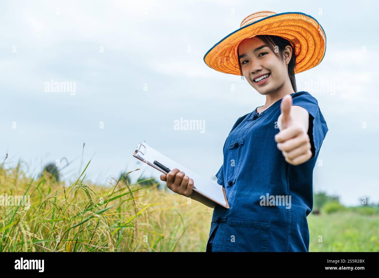Portrait Asian Young farmer woman wearing straw hat and holding ...