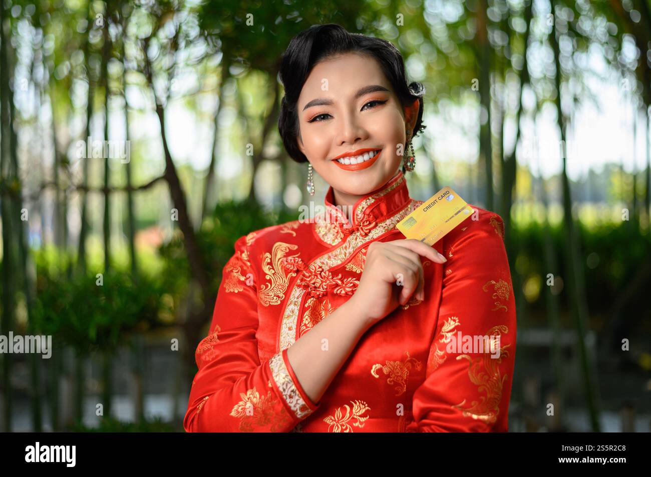 Portrait beautiful Asian woman in a Chinese cheongsam pose with credit ...