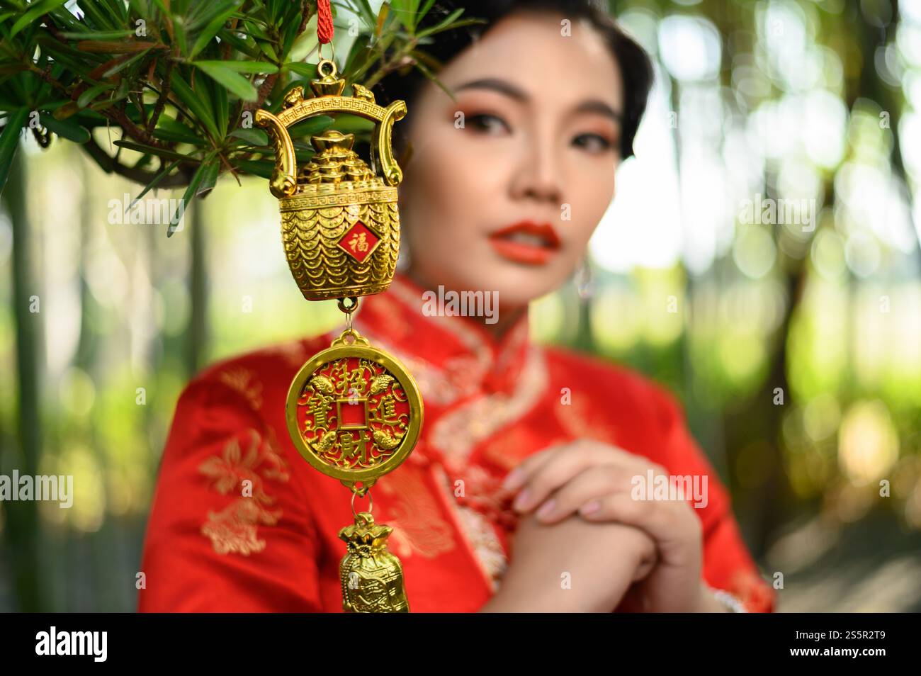 Pretty Asian woman in a Chinese cheongsam smile and looking Golden ...
