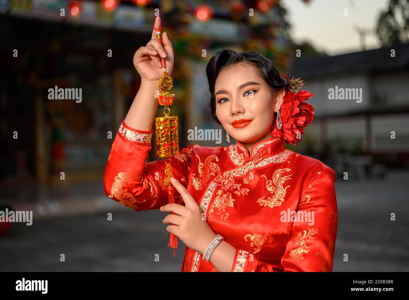 Portrait Asian beautiful woman wearing a cheongsam smiling and holding ...