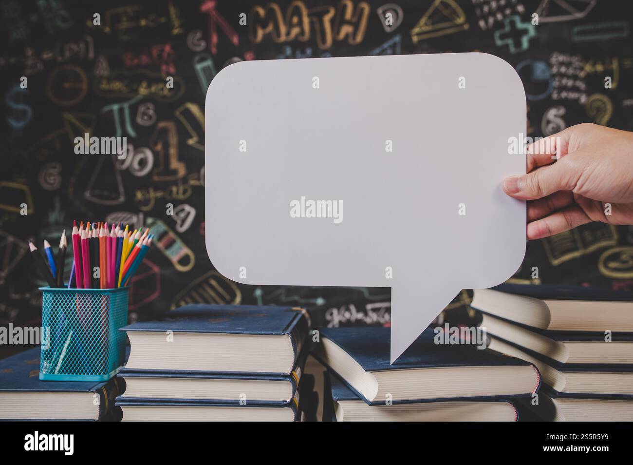 hand holding speech bubble in class room Stock Photo - Alamy